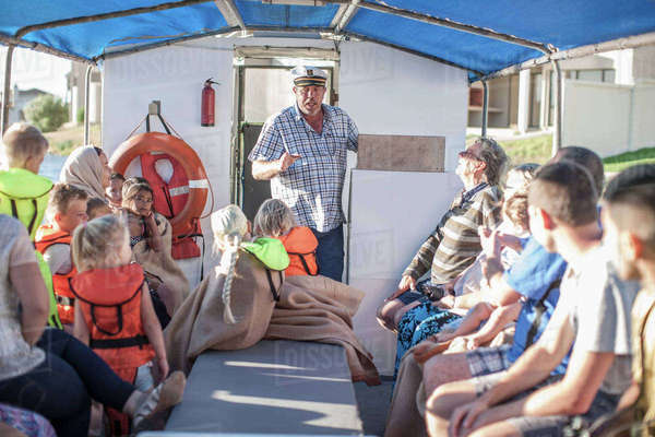 Captain talking to tourists on boat trip, Cape Town, South Africa ...