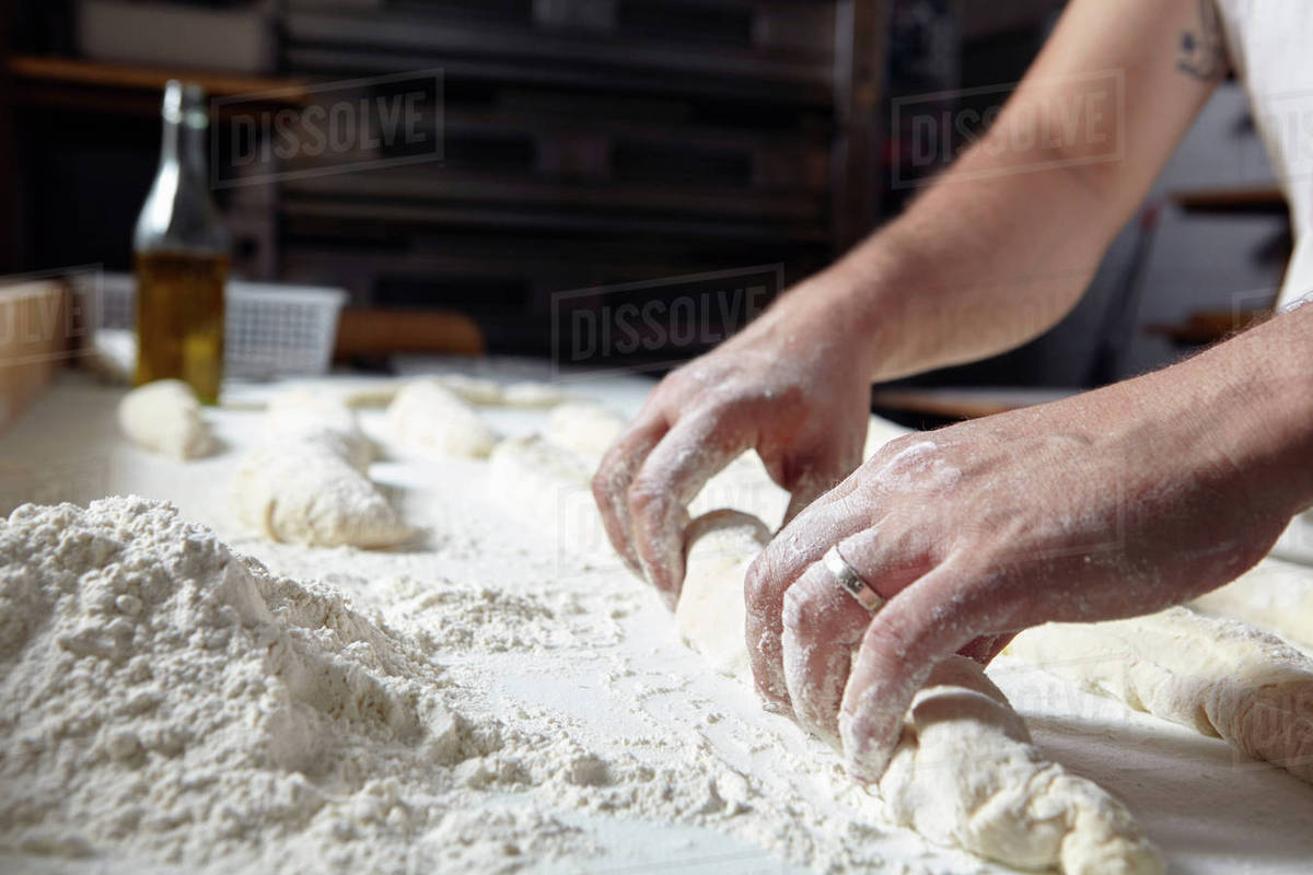 Baker working in bakery, mid section - Royalty-free Stock Photo | Dissolve