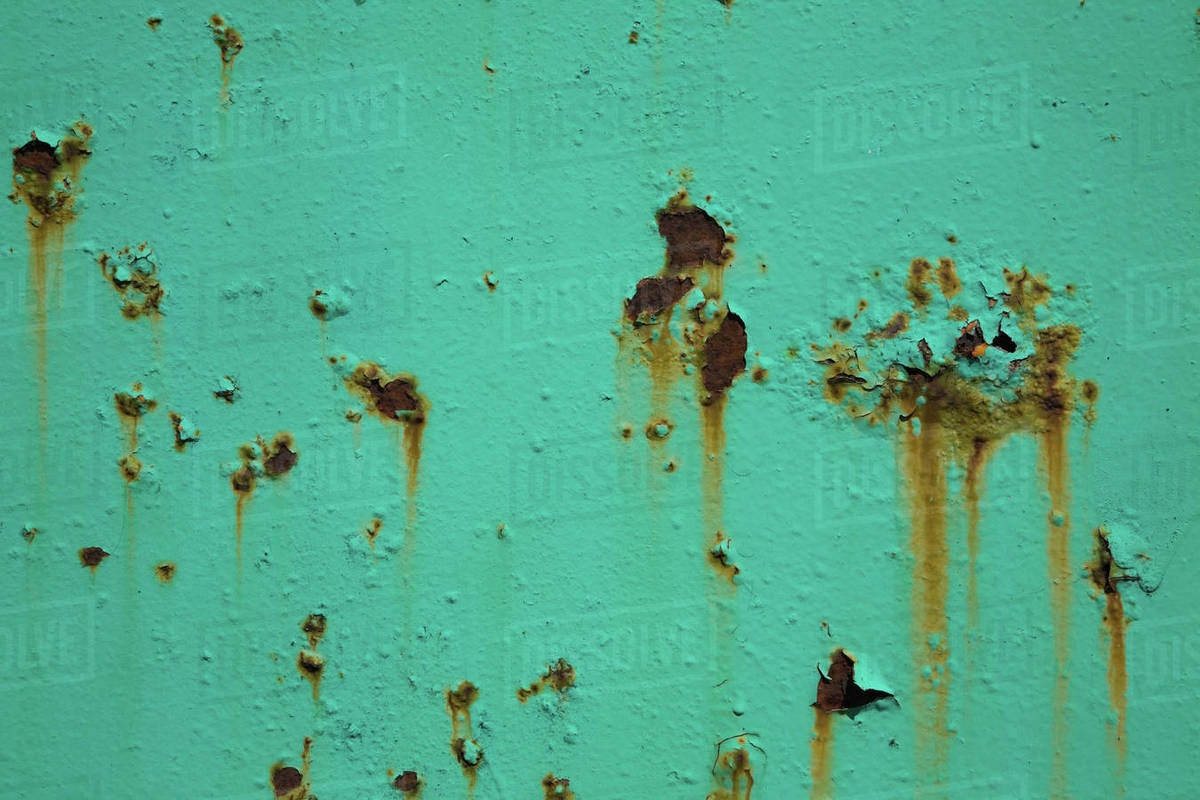 Peeling turquoise paint and rust on metal surface - Stock Photo - Dissolve