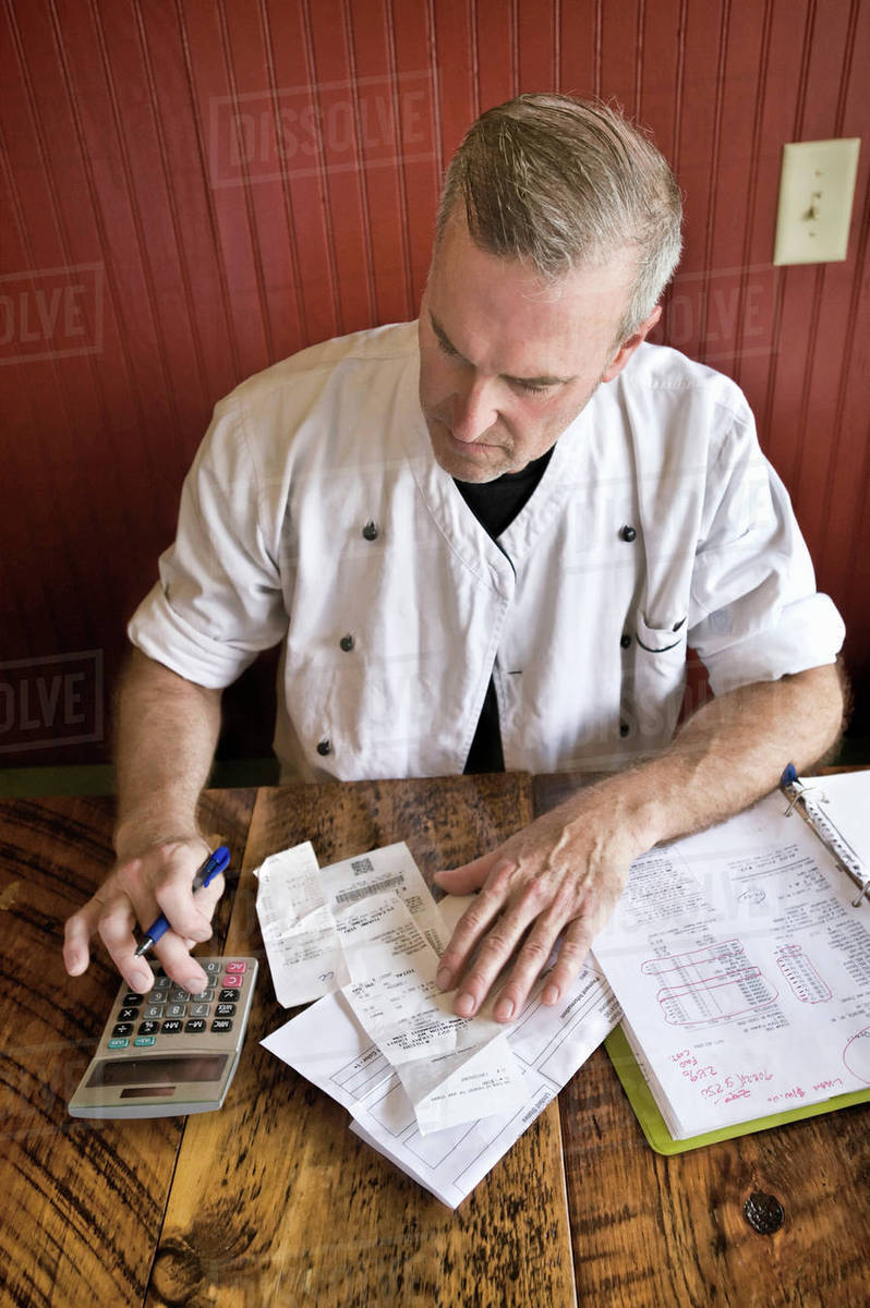 Chef working on accounts - Royalty-free Stock Photo | Dissolve
