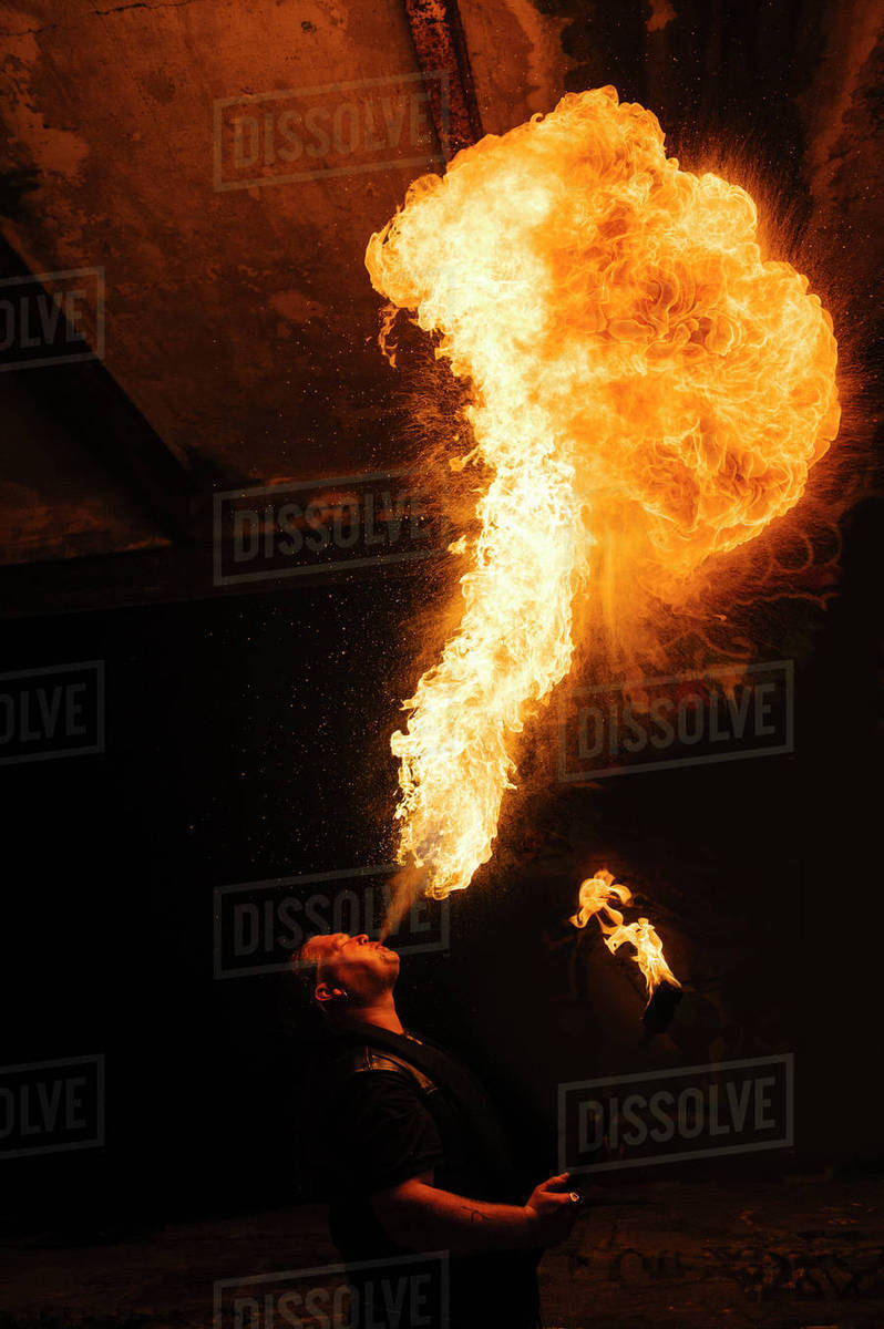 Man fire breathing in urban area - Royalty-free Stock Photo | Dissolve
