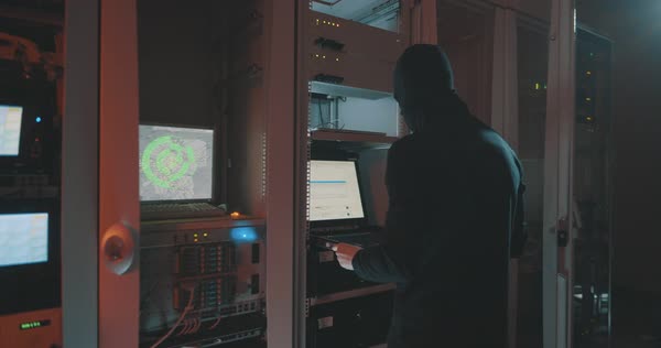 Hacker in mask leaves crime scene at data centre - 4K Royalty-free ...