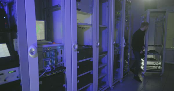 Hacker enters server room and starts to type code - Stock Video Footage ...