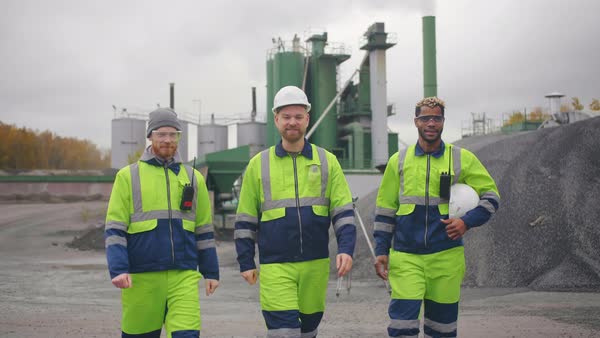 Dream team. Cheerful industrial engineers smiling at camera standing ...