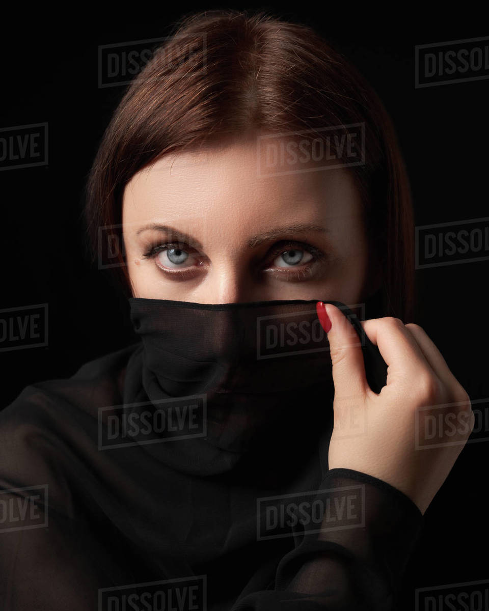 Shy brunette woman covered her nose and mouth or face with headscarf ...