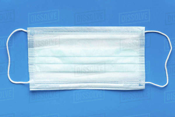 Medical surgical face mask on blue background. World pandemic insurance ...