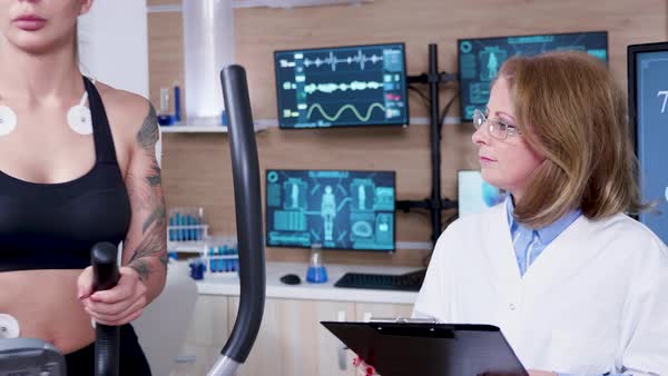 Female doctor in sport science working with beautiful female athlete ...