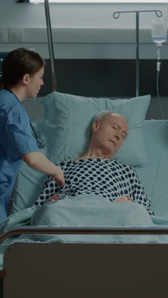 Vertical video: Patient going unconscious in hospital ward after ...