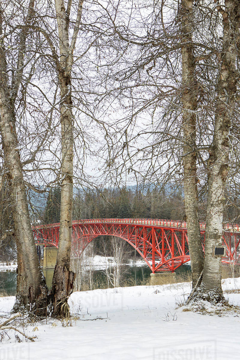 The red bridge spanning over the river during winter time in Ione ...