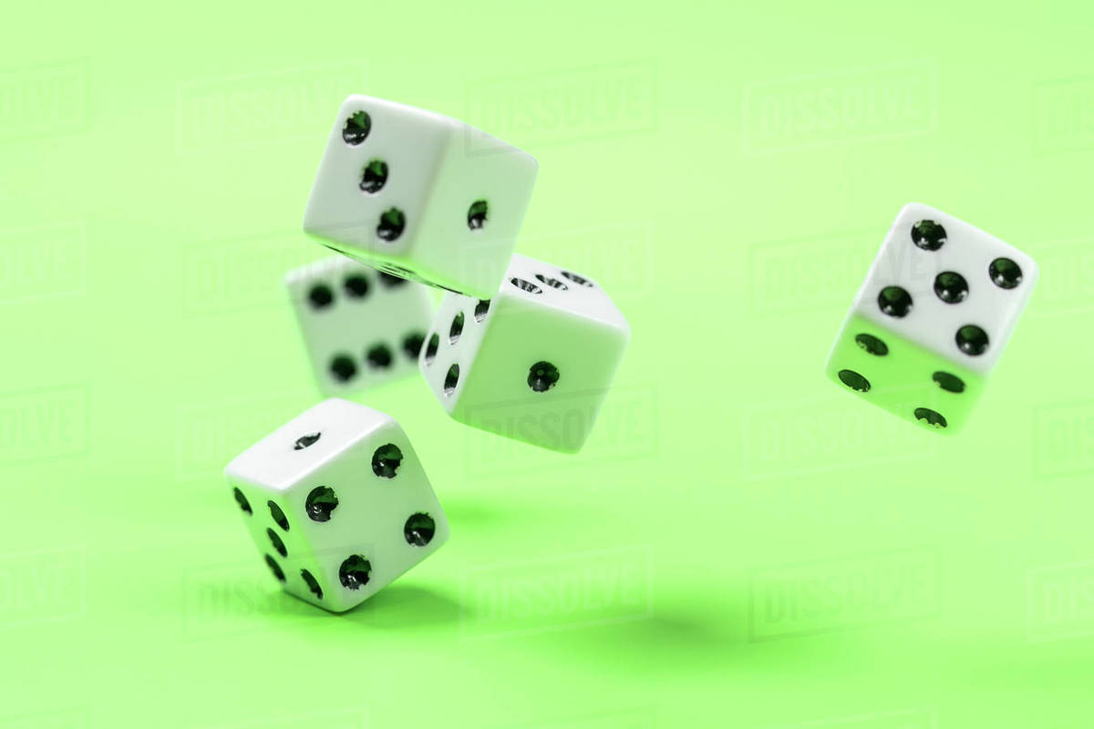 A conceptual photo of dice being rolled on a green table. - Royalty ...