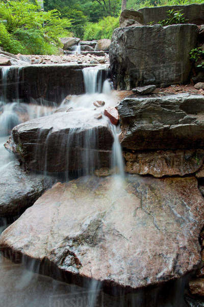 Cascading over rocks. - Stock Photo - Dissolve