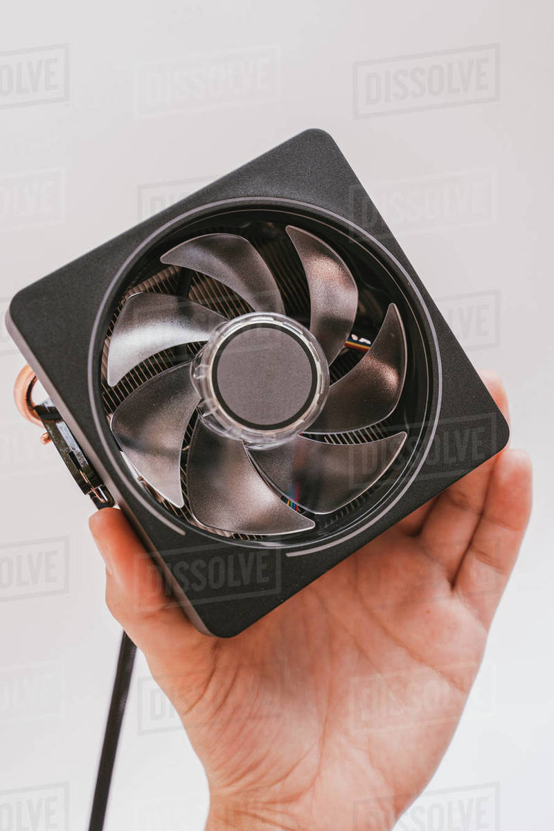 Hand holding CPU fan. PC cooling. Isolated on white. - Royalty-free ...