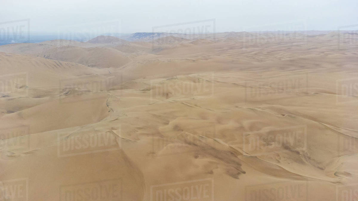 Aerial view of the dunes in the Ica desert in Peru - Stock Photo - Dissolve