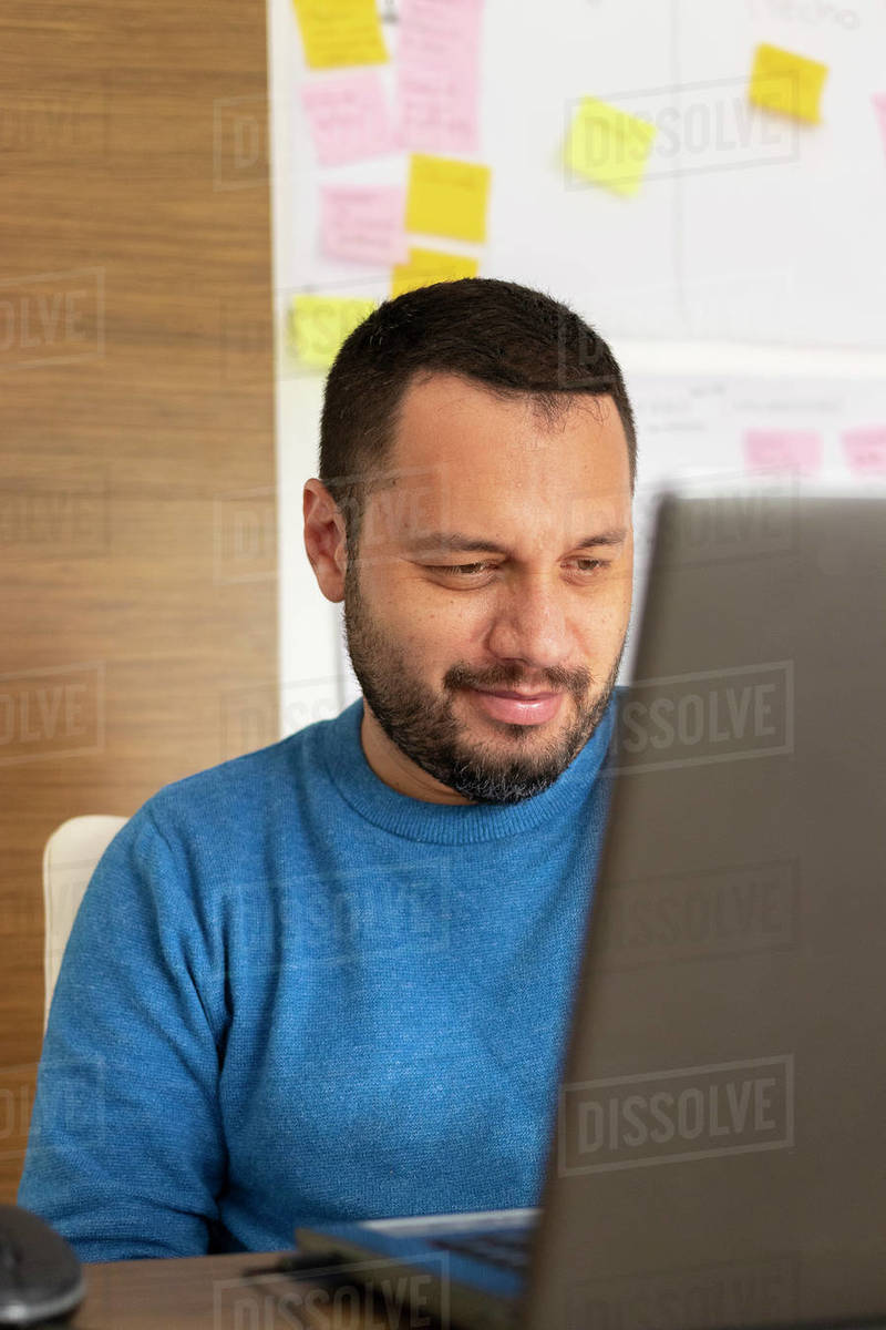 Young man working with his laptop - Royalty-free Stock Photo | Dissolve