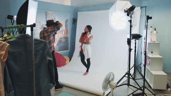 In professional equipment studio: attractive black model posing for a ...