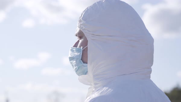 Side view close-up of sad Caucasian man in face mask taking off ...