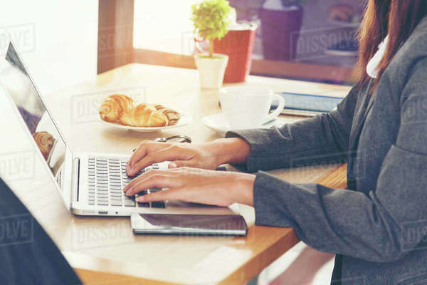 Side view of young working woman using laptop. - Royalty-free Stock ...
