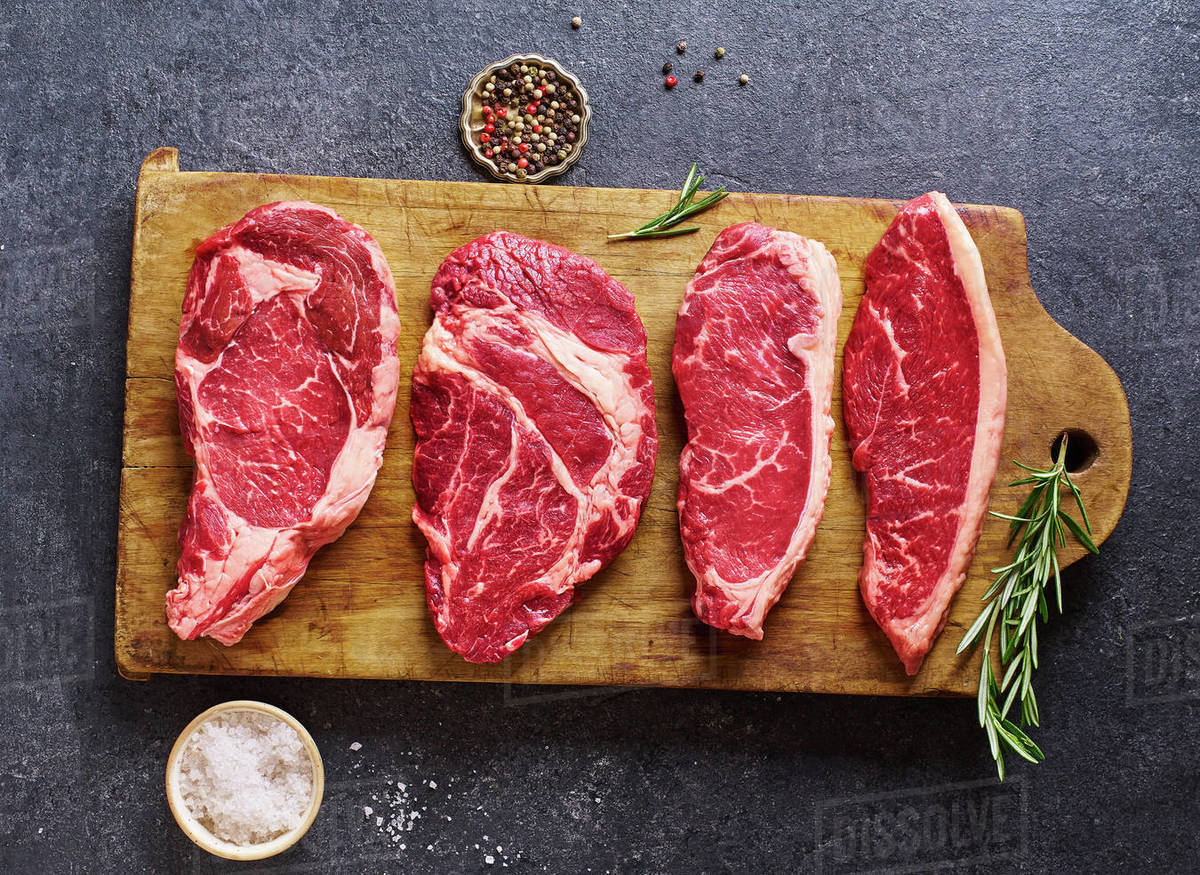 Variety of fresh Black Angus Prime raw beef steakes: ribeye, striploin ...
