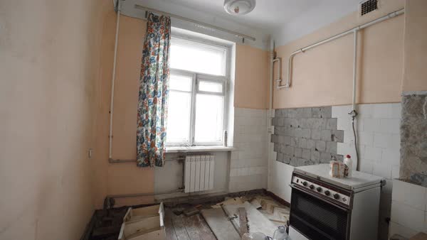 Repair in the apartment. Old neglected kitchen Ruined torn floor from ...