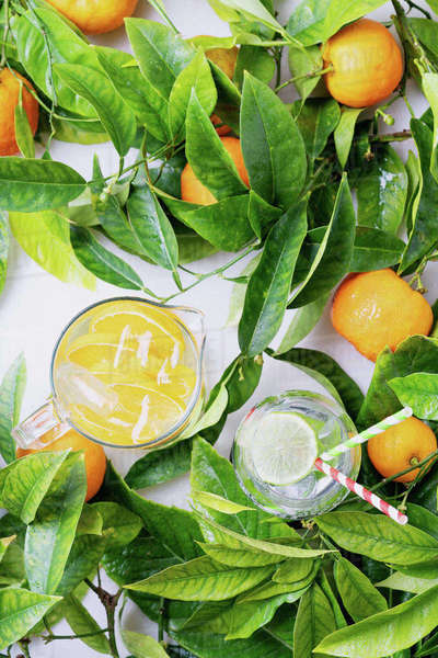 Homemade citrus infused water in a jug and in a glass with ice and ...