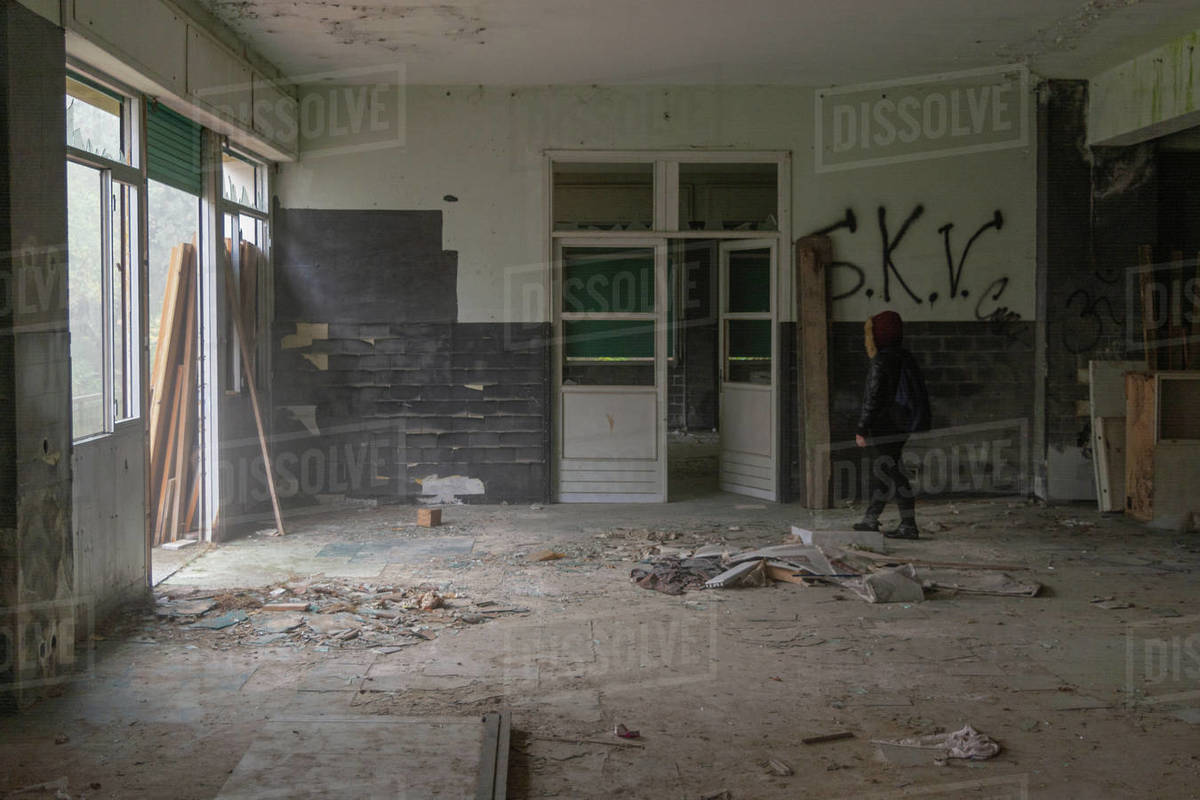 Old abandoned house decay hall with girl exploring it in the wood with ...