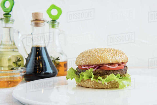 Tasty classical burger with meat cheese lettuce onion, tomato and sauce ...