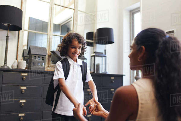 Mother holding son's hands before leaving for school - Stock Photo ...
