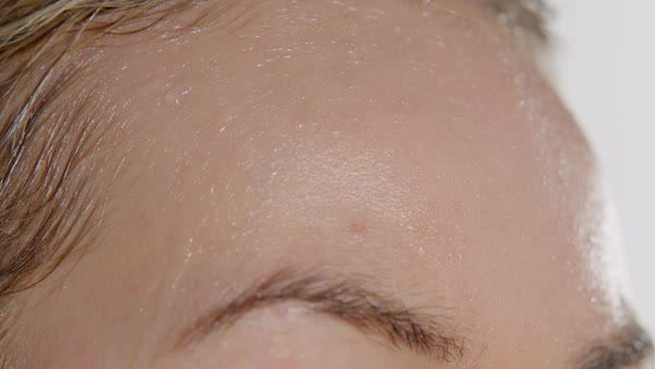 Close-up of sweat forming on a woman's forehead. - Stock Video Footage ...