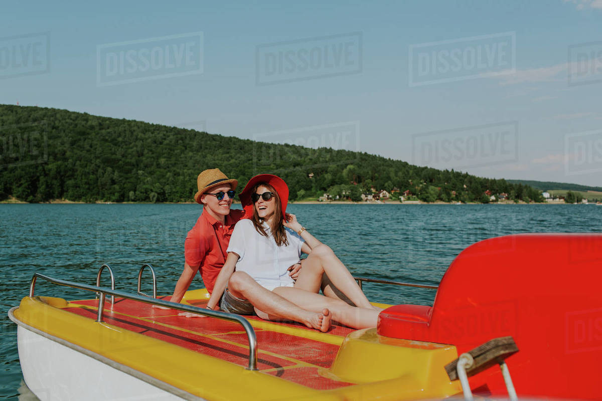 Man and woman having fun while boating. Portrait of couple in love ...