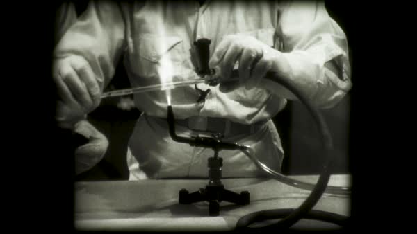 Close-up shot of a scientist burning a glass tube on Bunsen burner ...