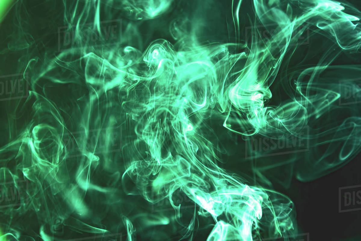 Green abstract shaped smoke against black background. Abstract ...