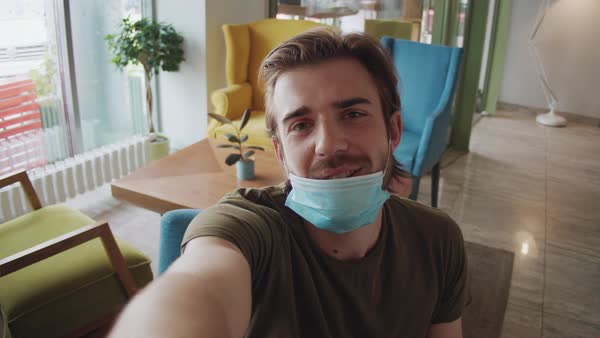 man in medical mask during video conference call on the phone, video ...