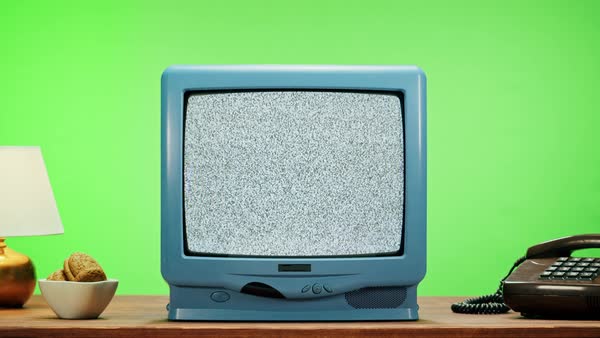 Old television with grey screen on chroma green background. Close-up of ...