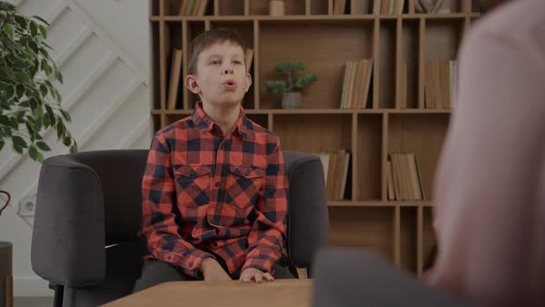 School boy with autism doing speech assignments. Child with autism ...