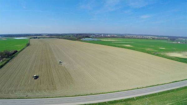 Beautiful flat land nature with farm lands everywhere. Two tractors ...