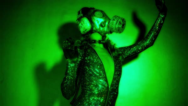 Woman dances with a gas mask covered in sparkling crystals, in bling ...