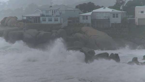 Locked off long shot of seaside houses during storm, Cape of Storms ...