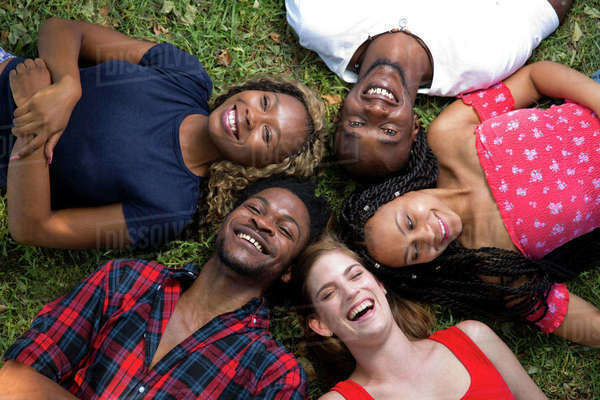 Group of friends lying on the grass laughing - Royalty-free Stock Photo ...