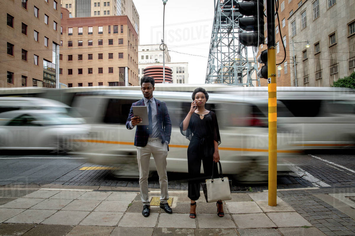 Business man and woman waiting at traffic light - Royalty-free Stock ...