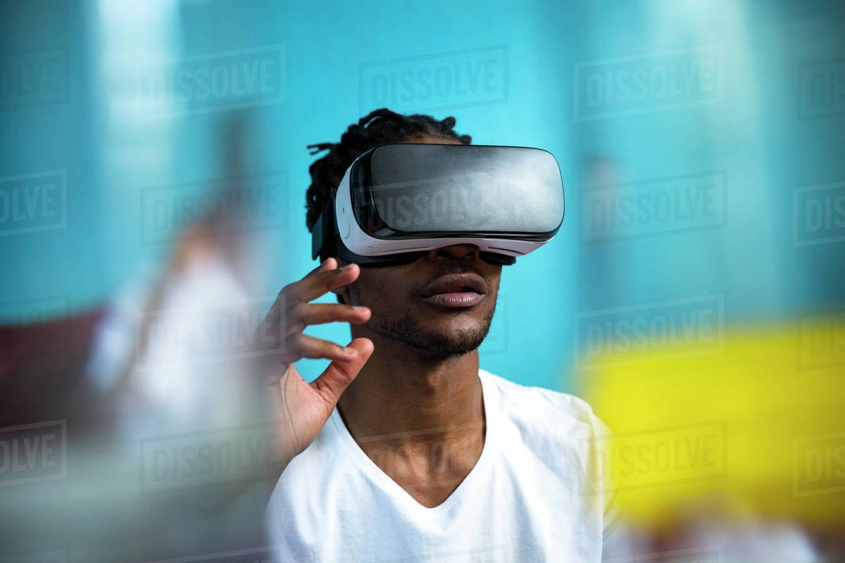 African man looking through VR headset - Royalty-free Stock Photo ...