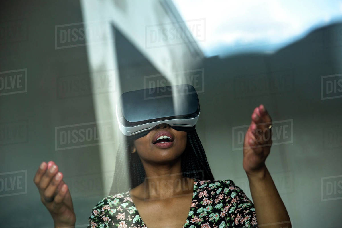 African woman looking through VR headset - Royalty-free Stock Photo ...
