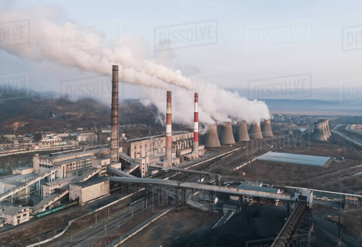 Aerial view of smoking pipes and cooling towers of coal thermal power ...