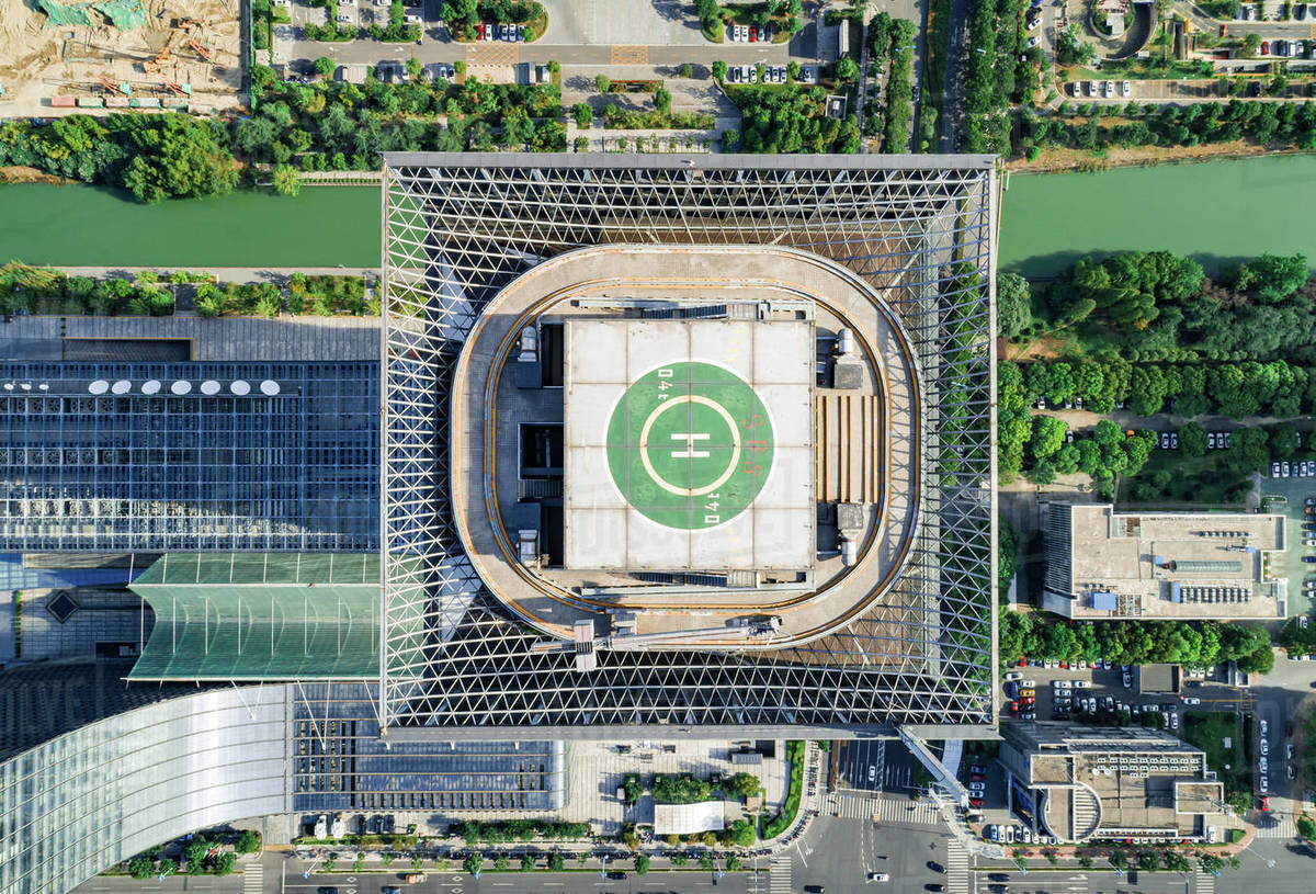 Aerial drone view of helipad on the roof of a skyscraper in downtown ...