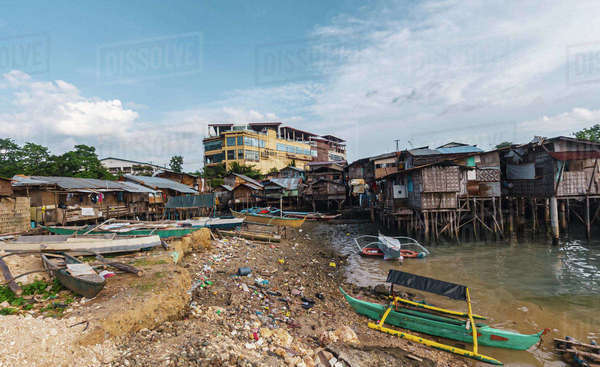 A coastal slum in the Philippines. The structures built on stilts rise ...