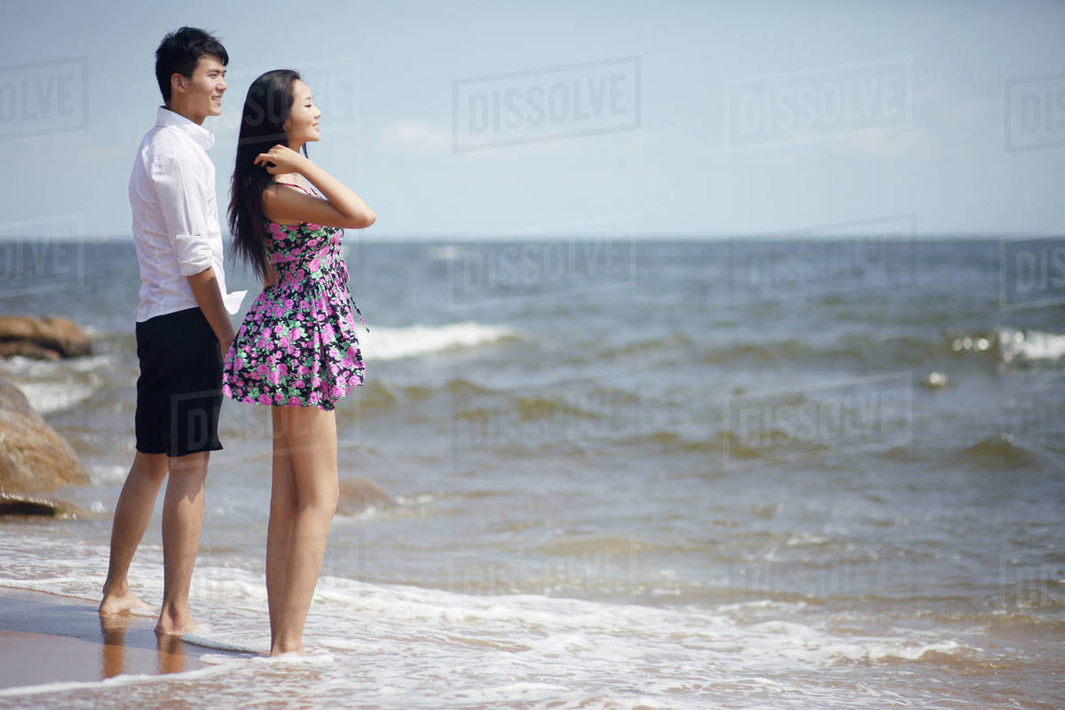 Couple standing on seaside - Royalty-free Stock Photo | Dissolve
