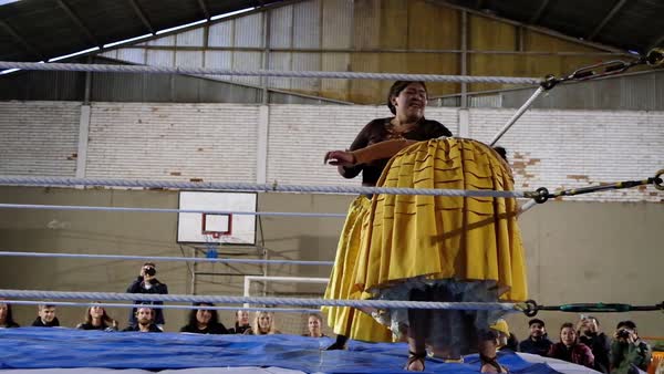 Female woman cholita wrestlers in native costume fight in a boxing ring ...