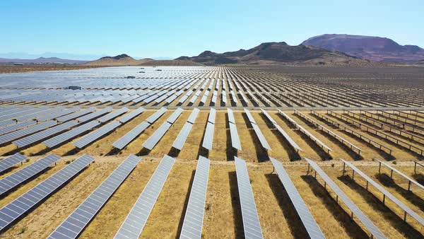 Forward drone aerial of vast solar array in Mojave Desert, California ...