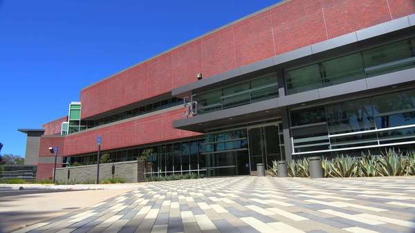 Establishing shot of the exterior of a generic modern office building ...