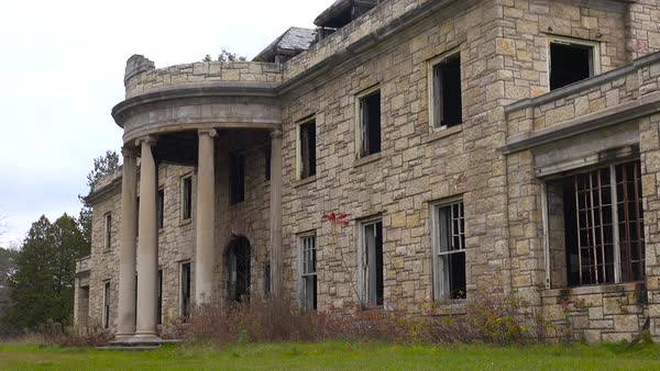 Facade of an abandoned and spooky old boarding school or mansion in the ...
