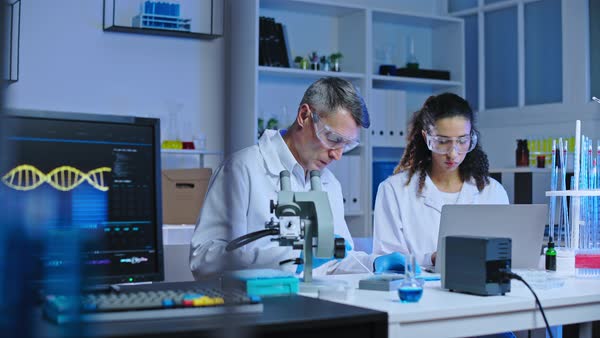 DNA laboratory scientists conducting experiment with blood samples ...